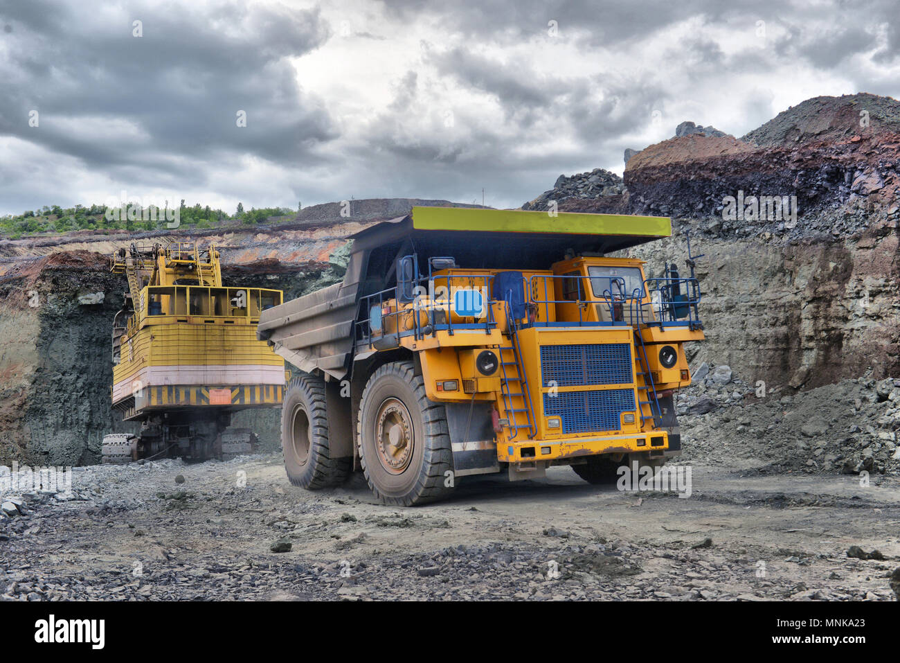 Large quarry dump truck. Loading the rock in the dumper. Loading coal into body work truck ...