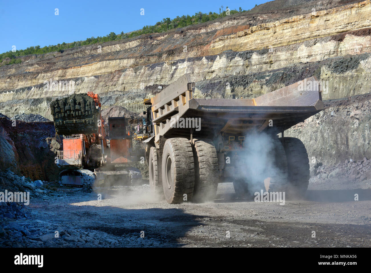 Large quarry dump truck. Loading the rock in the dumper. Loading coal into body work truck ...