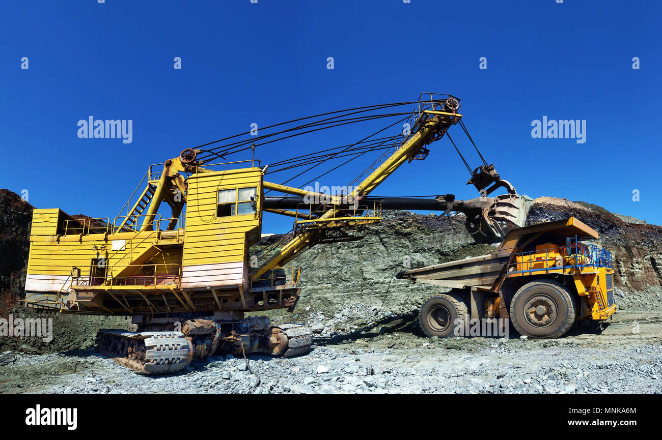 Large quarry dump truck. Loading the rock in the dumper. Loading coal ...