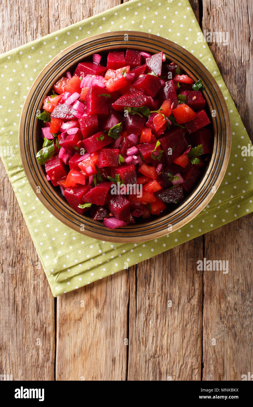 Moroccan beetroot salad with onions, tomatoes and herbs close-up on the ...