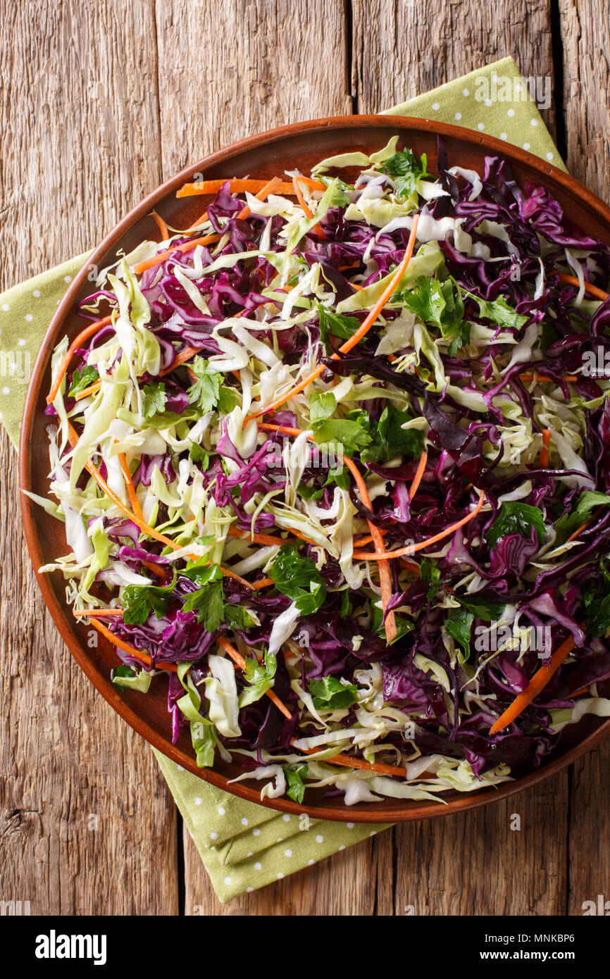 Mix salad of white and red cabbage with carrots, onions, herbs with ...