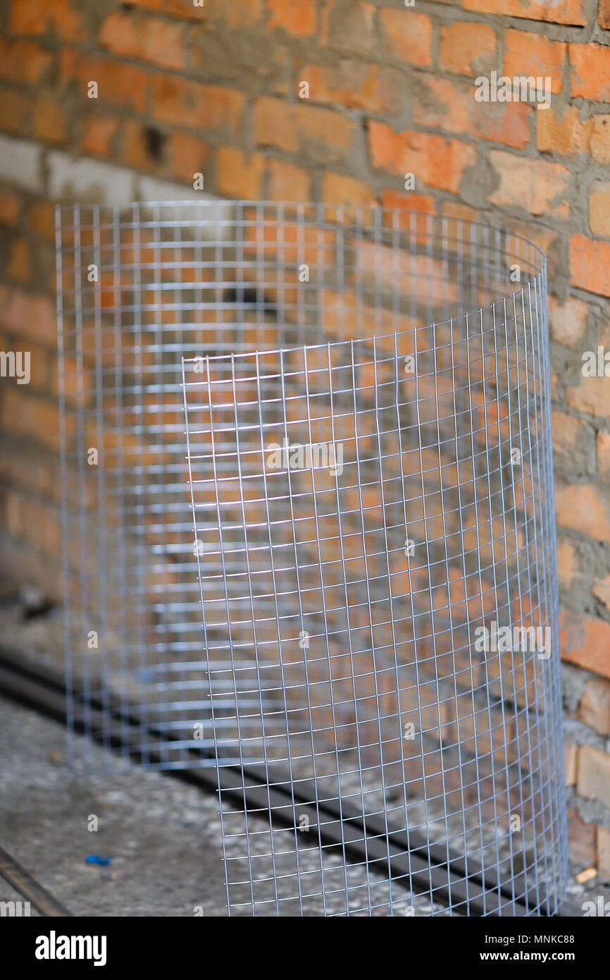 Sheet of metall grid with brick wall in background Stock Photo - Alamy