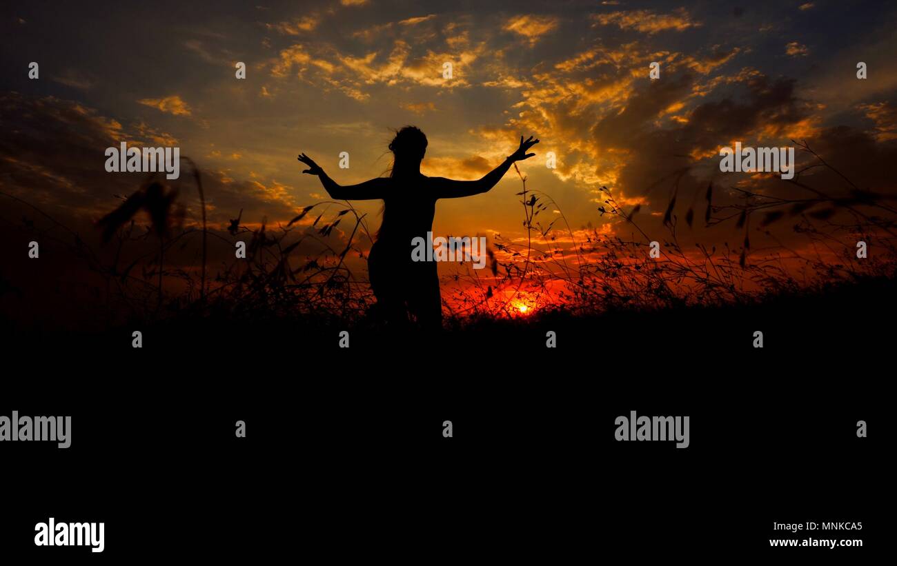 Female shadow silhouette doing yoga in sunset steppe background Stock ...