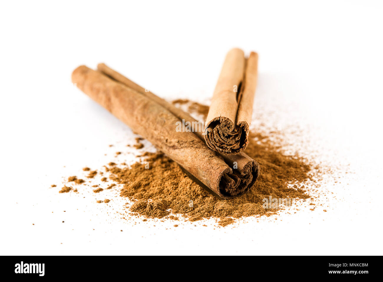 Cinnamon sticks and powder isolated on white background Stock Photo - Alamy