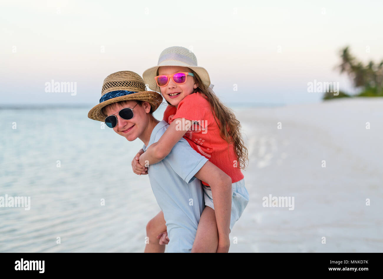 Portrait of kids having fun during tropical summer vacation playing ...