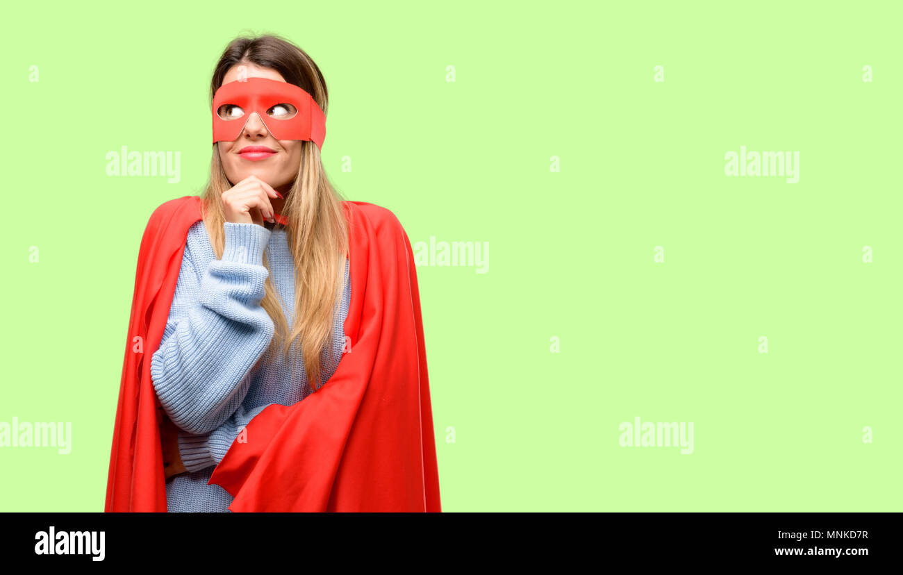 Young super woman thinking and looking up expressing doubt and wonder ...