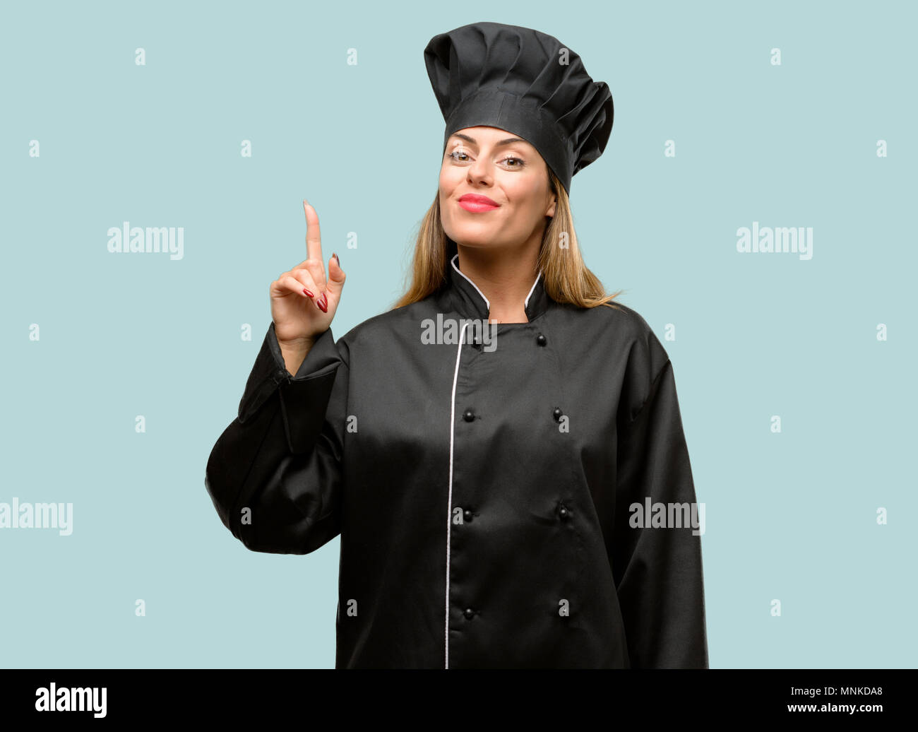 Young cook woman happy and surprised cheering expressing wow gesture ...