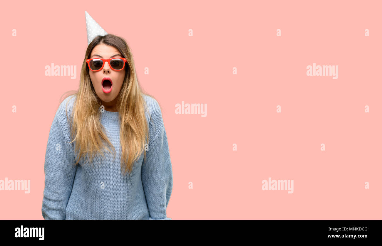 Young woman celebrates birthday scared in shock, expressing panic and ...