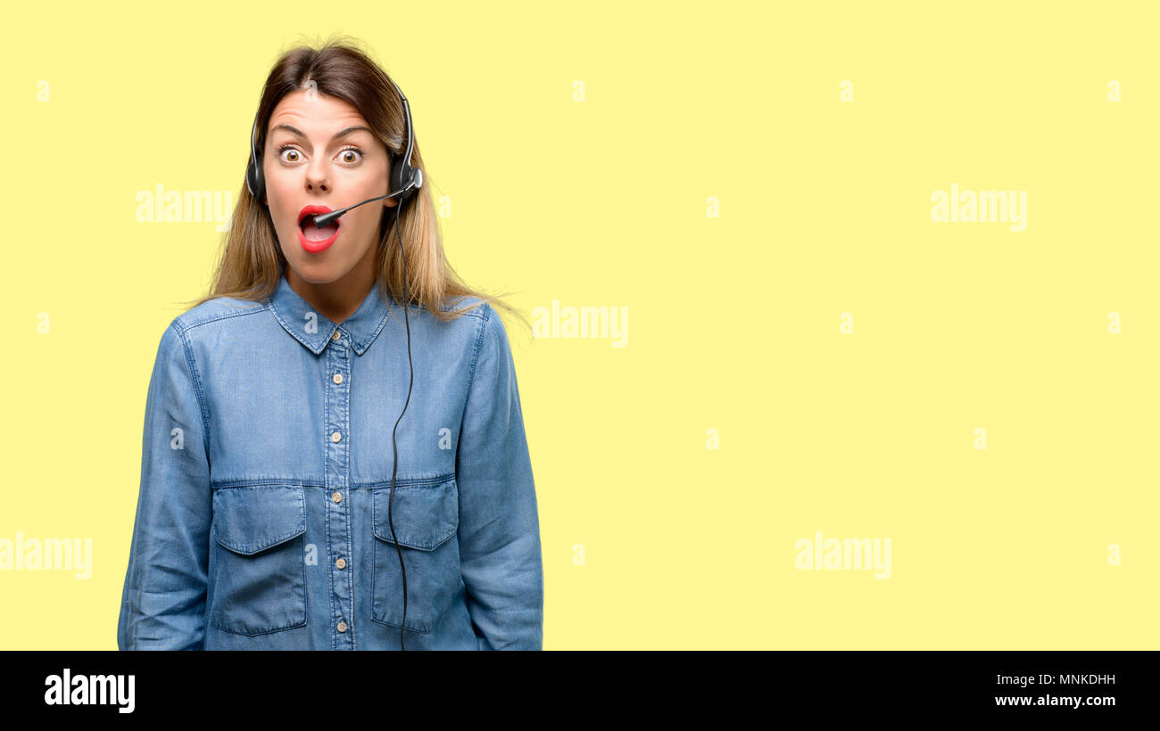 Consultant of call center woman in headphones scared in shock ...