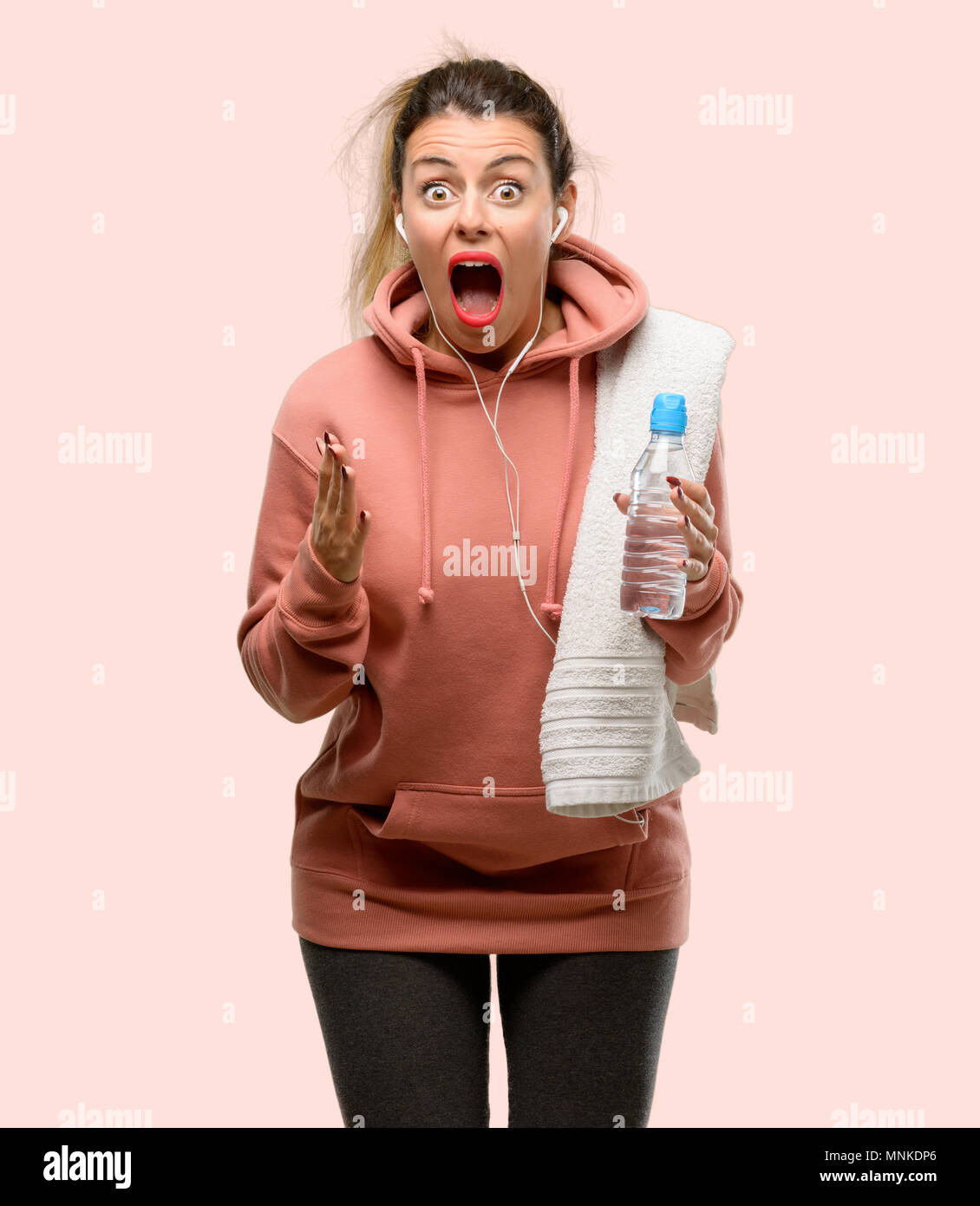 Young sport woman wearing workout sweatshirt stressful keeping hands on ...