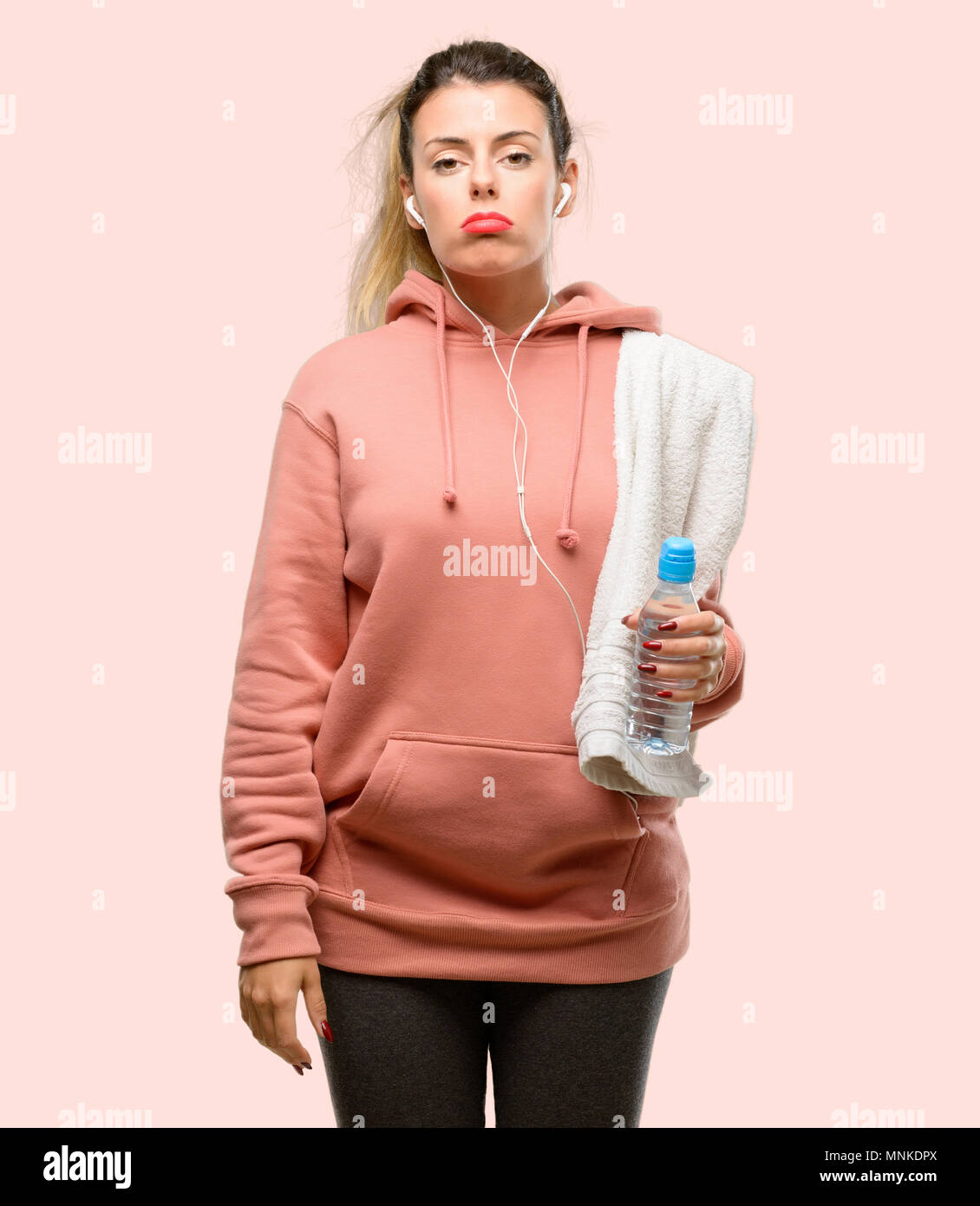 Young sport woman wearing workout sweatshirt with sleepy expression ...