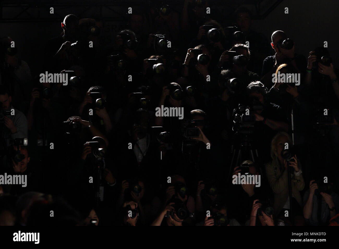 Photographers in the photographers pit at the end of the catwalk, side ...
