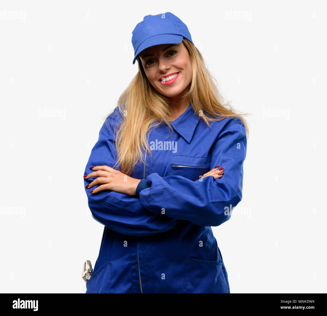 Young plumber woman with crossed arms confident and happy with a big ...