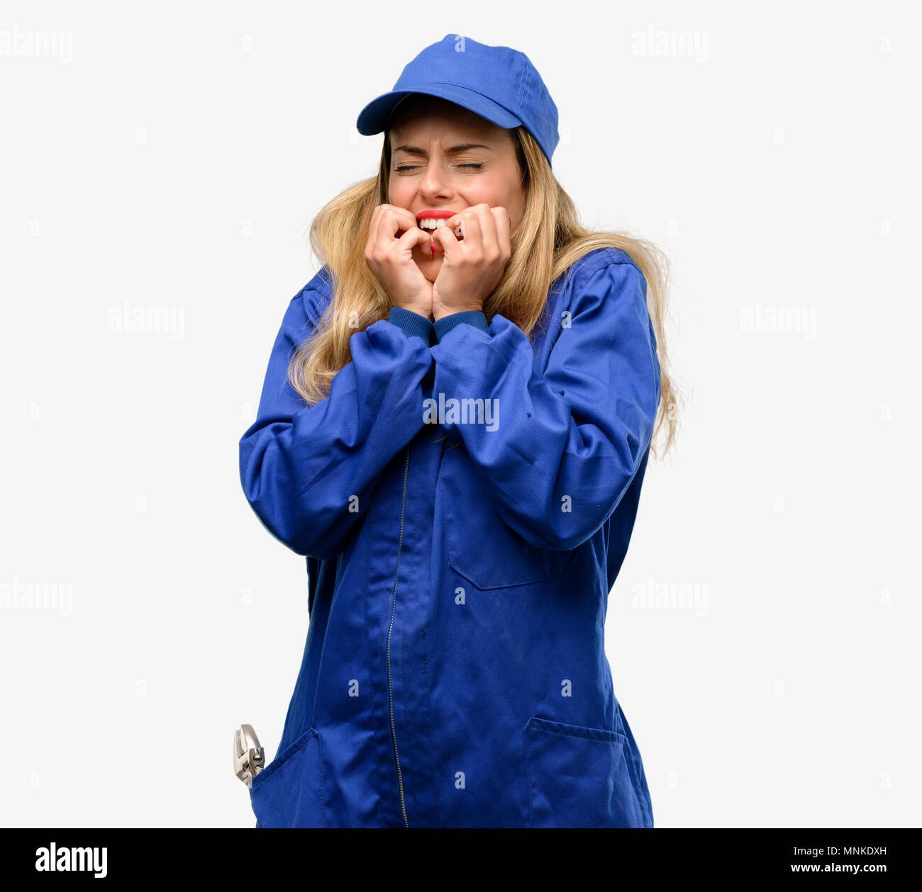 Young plumber woman terrified and nervous expressing anxiety and panic ...