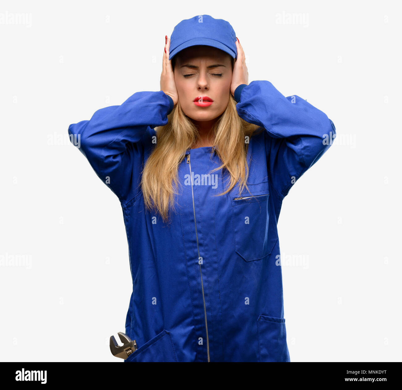 Young plumber woman covering ears ignoring annoying loud noise, plugs ...