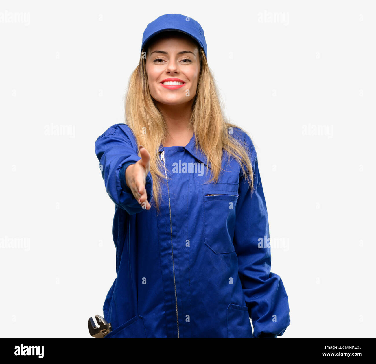 Young plumber woman holds hands welcoming in handshake pose, expressing ...