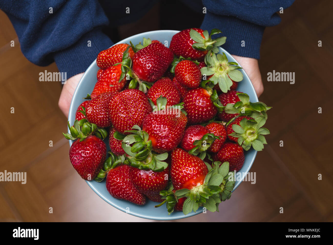 Adult male holding strawberries with both hands Stock Photo - Alamy