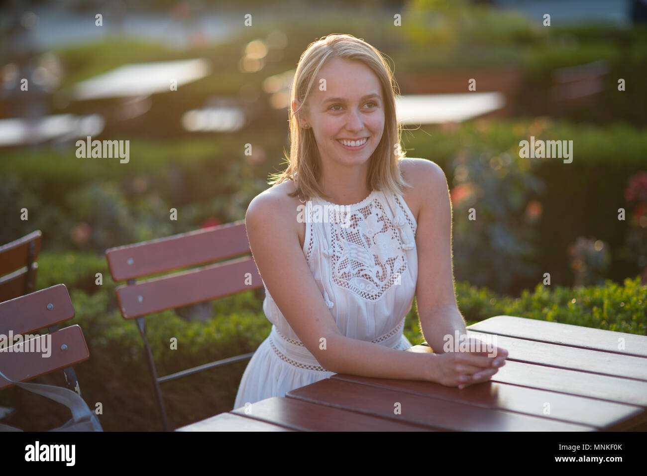 Beautiful woman sitting patio table hi-res stock photography and images ...