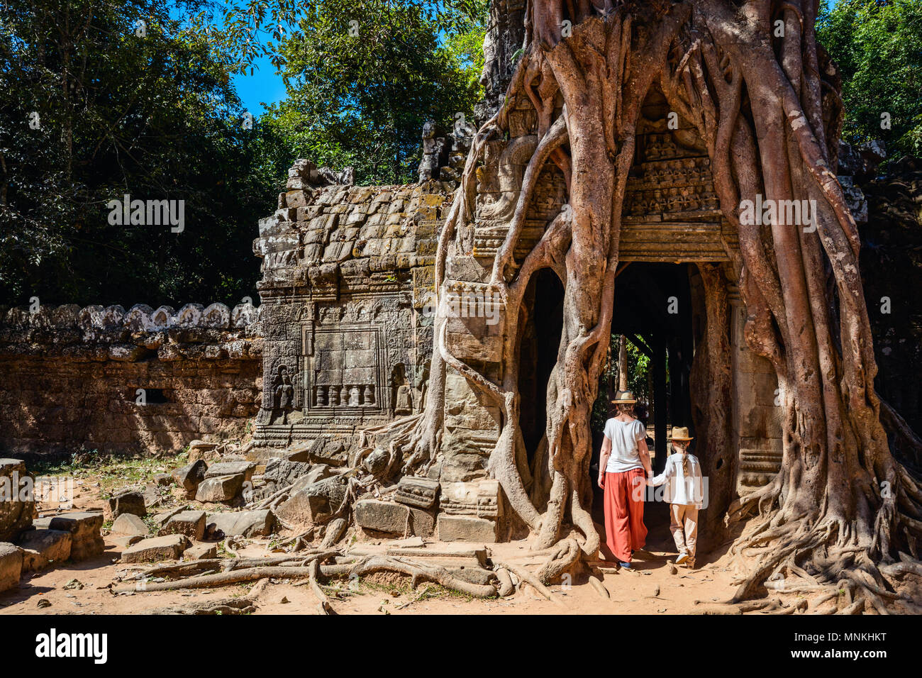 Family mother and child visiting ancient Ta Som temple in Angkor ...