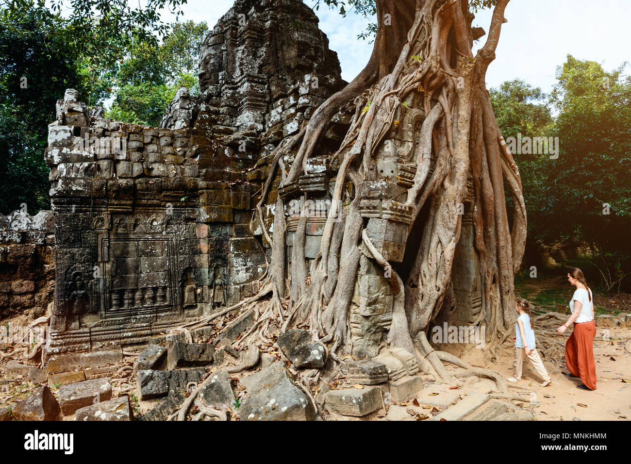 Family mother and child visiting ancient Ta Som temple in Angkor ...