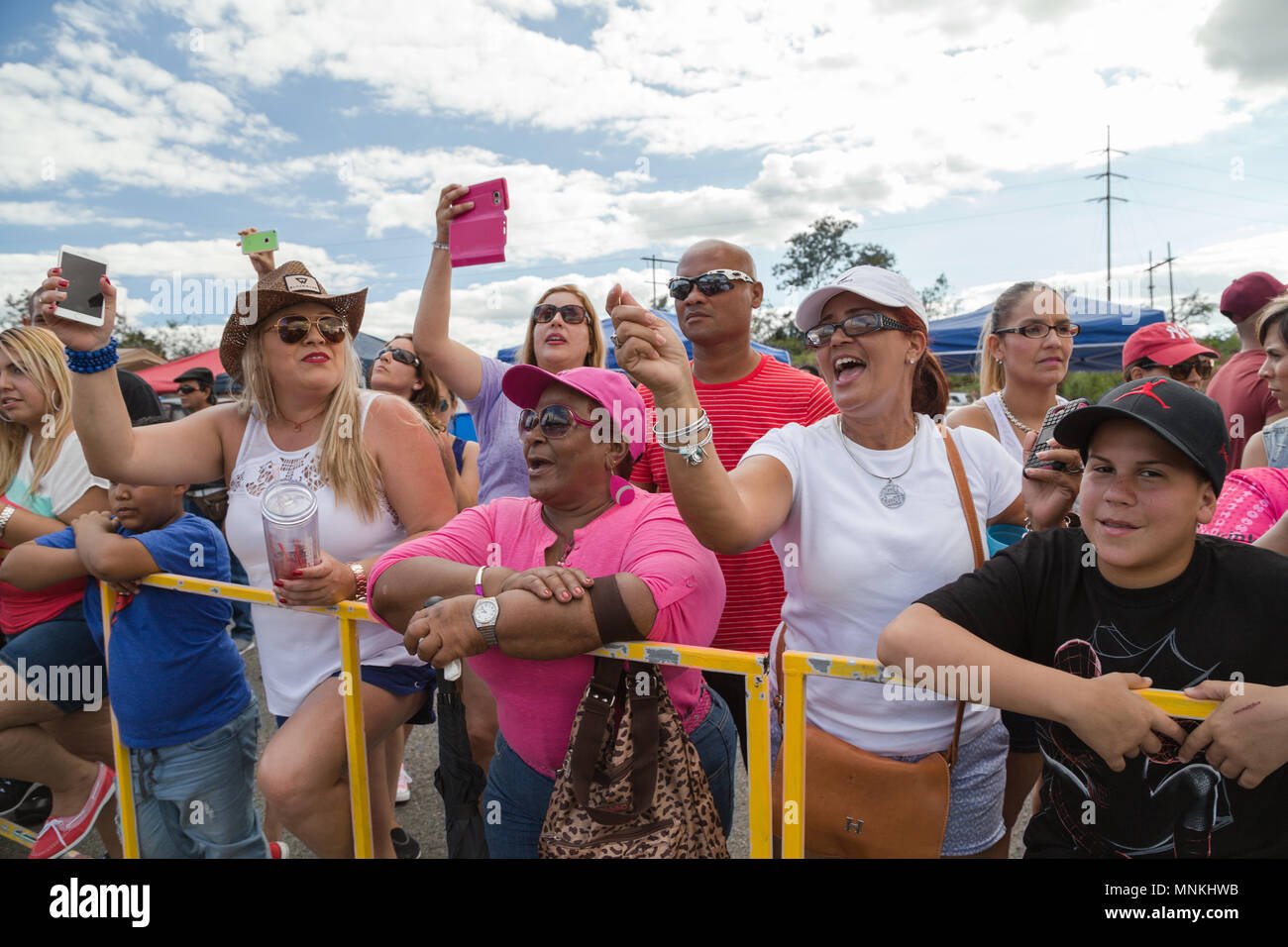People cheering and taking photographs to the performers at Fiesta de ...
