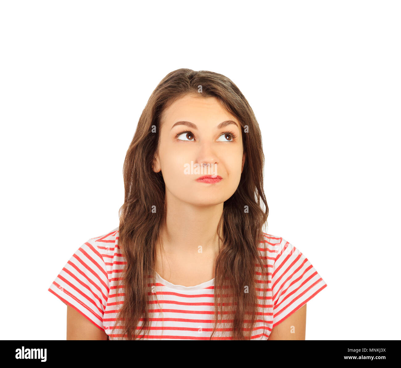 Close-up portrait of a casual pretty young smiling girl thinking about ...