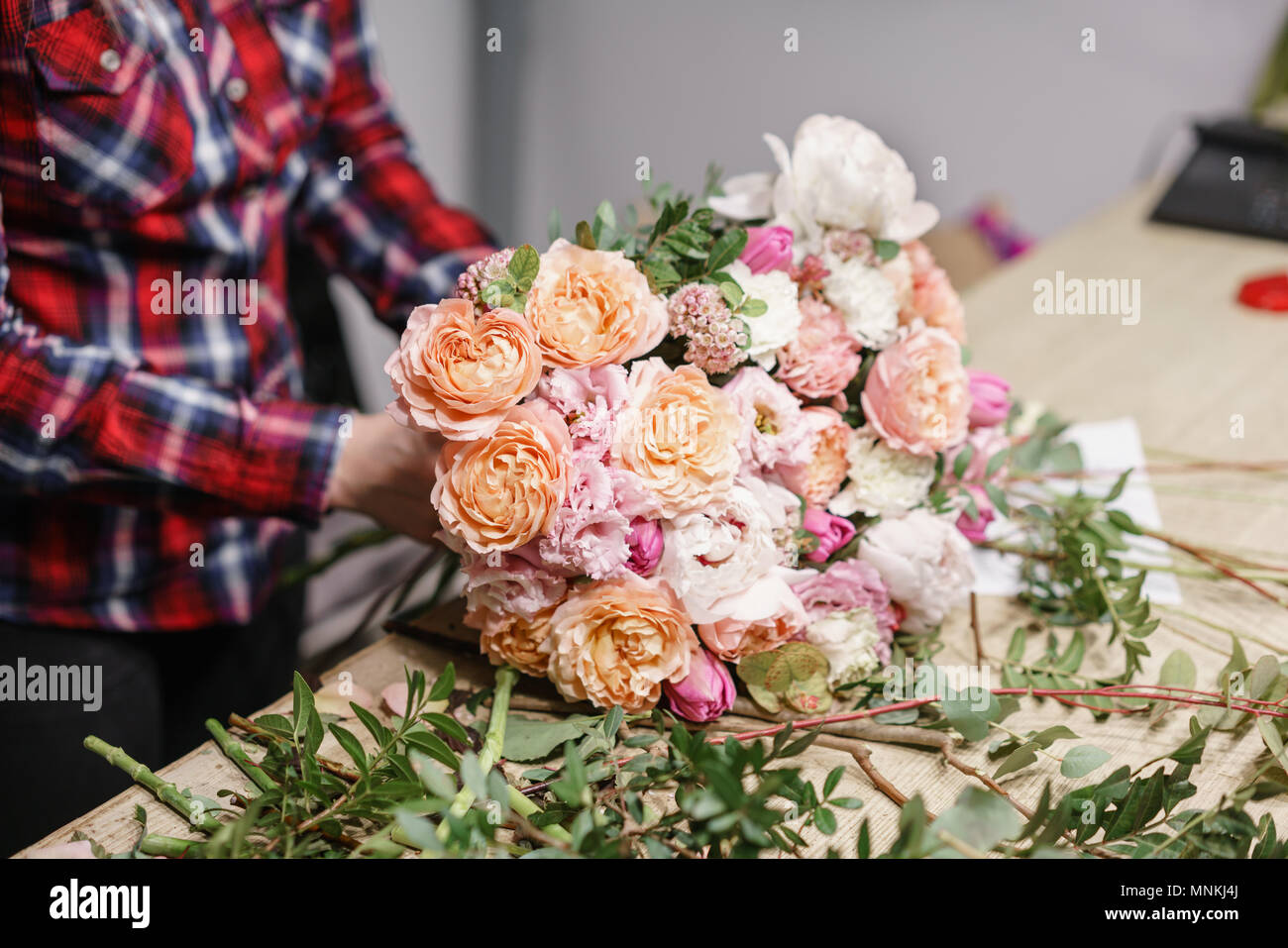 Female florist. Floral workshop - woman making a beautiful flower ...