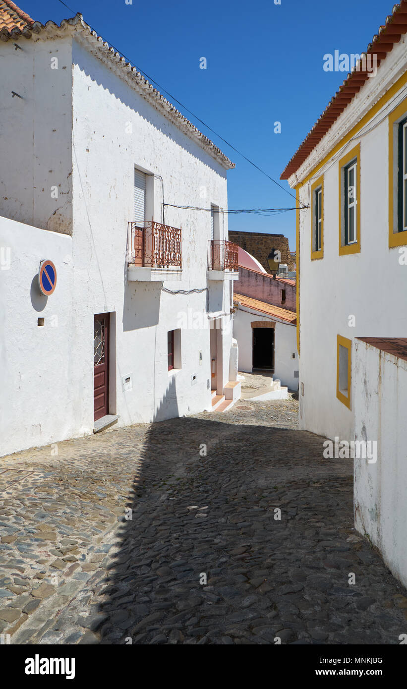 The cozy narrow paved streets with white Alentejo country-style houses ...