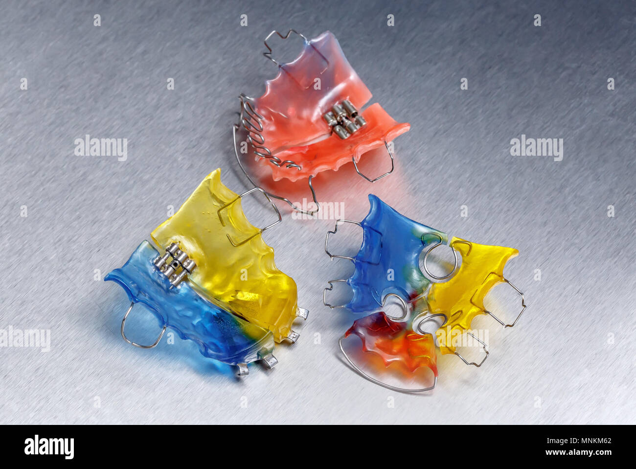 Three colorful dental braces or retainers for teeth on metall ...