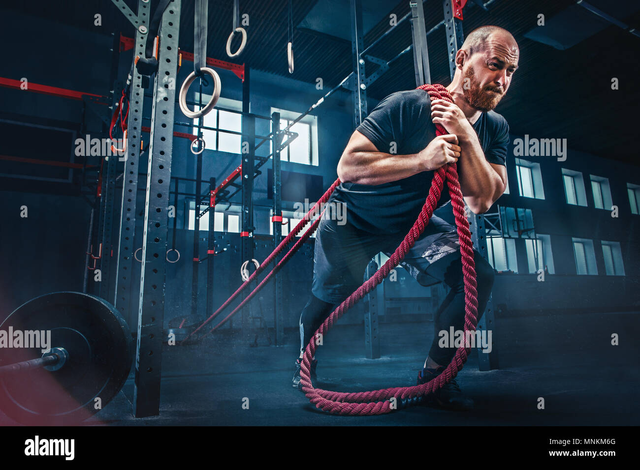 Men with battle rope battle ropes exercise in the fitness gym Stock ...