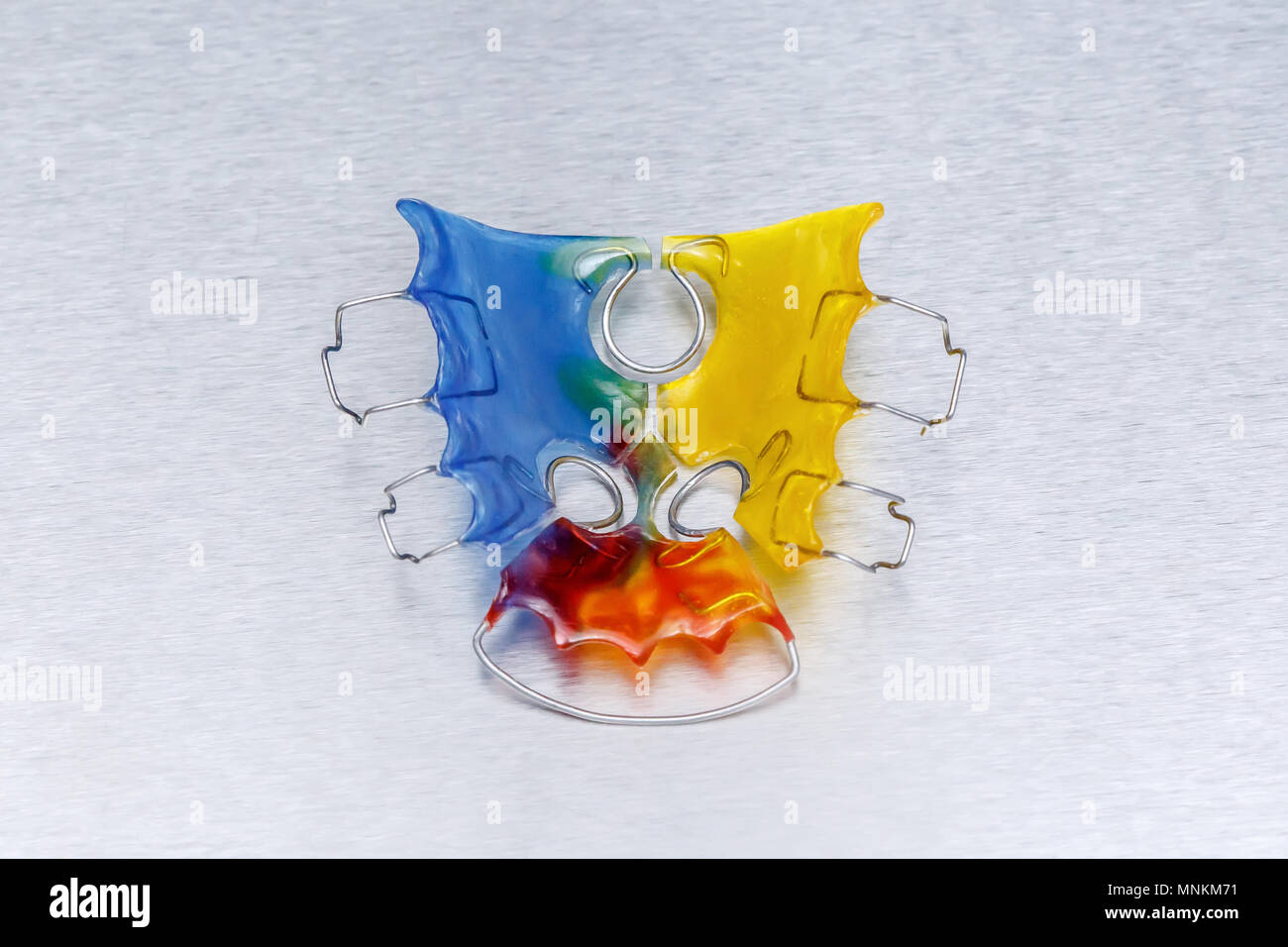 Colorful dental braces or retainer for teeth on metall background ...