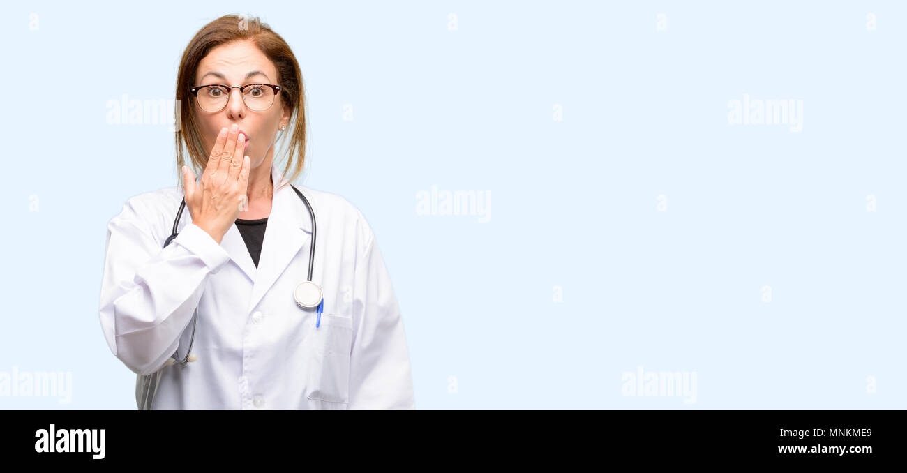 Doctor woman, medical professional covers mouth in shock, looks shy ...