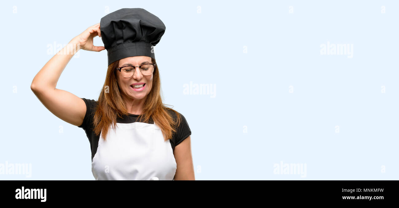 Middle age cook woman wearing chef apron doubt expression, confuse and ...