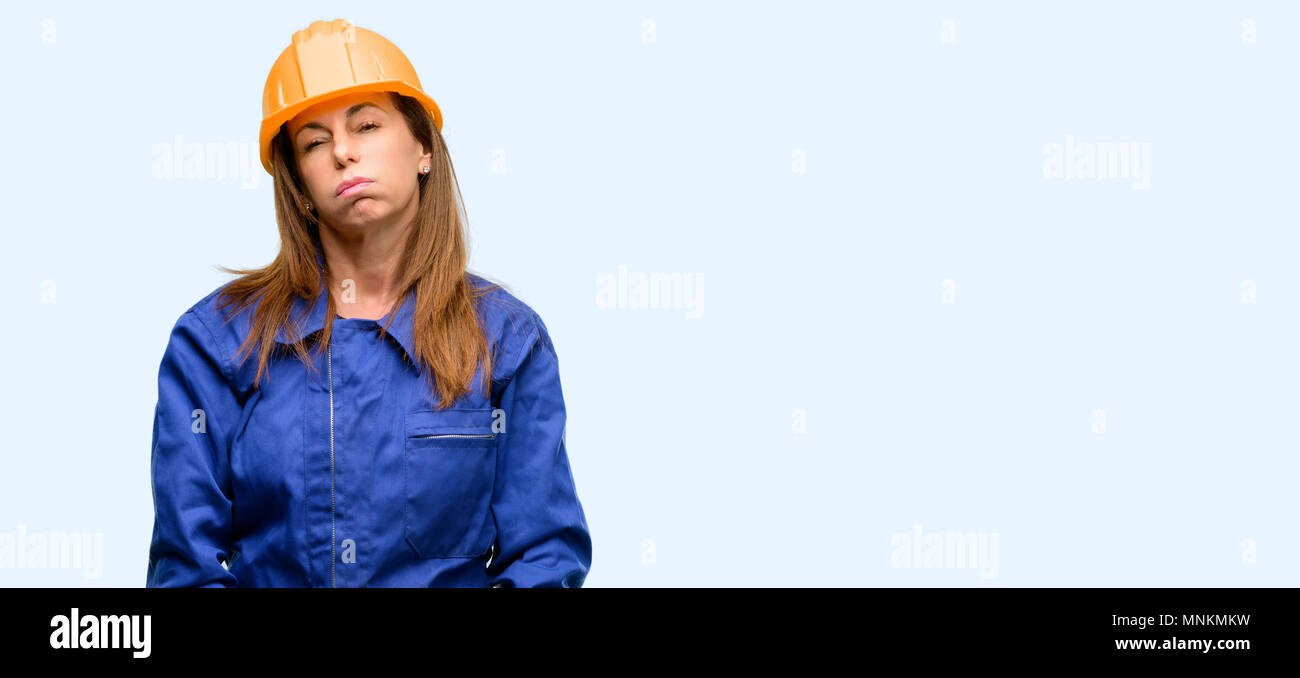Engineer construction worker woman with sleepy expression, being ...
