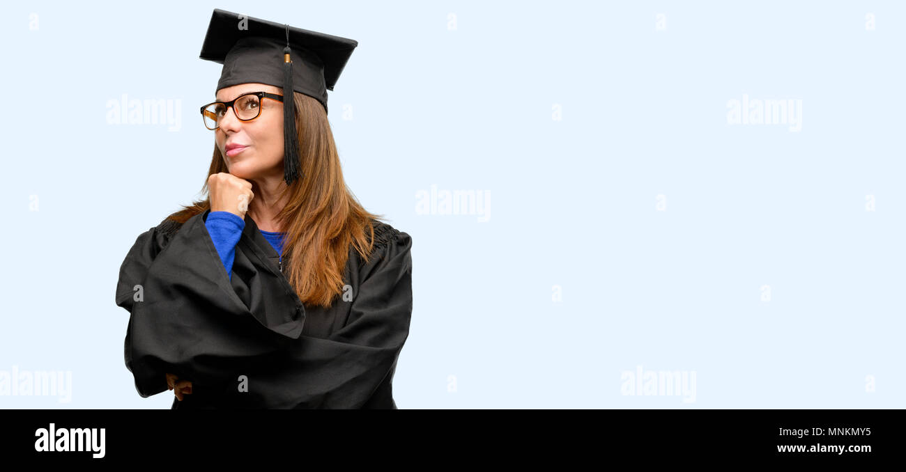 Senior graduate student woman thinking and looking up expressing doubt ...