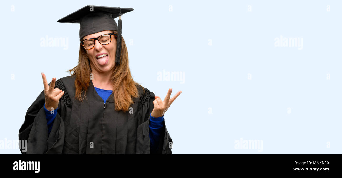 Senior graduate student woman looking at camera showing tong and making ...