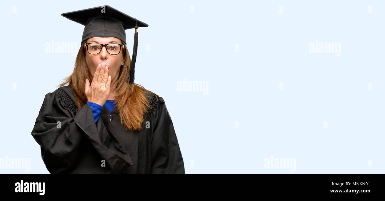 Senior graduate student woman covers mouth in shock, looks shy ...