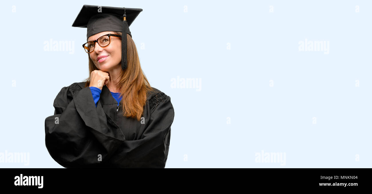 Senior graduate student woman thinking and looking up expressing doubt ...