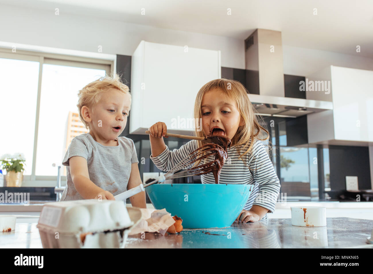 Boy mixing chocolate in kitchen hi-res stock photography and images - Alamy