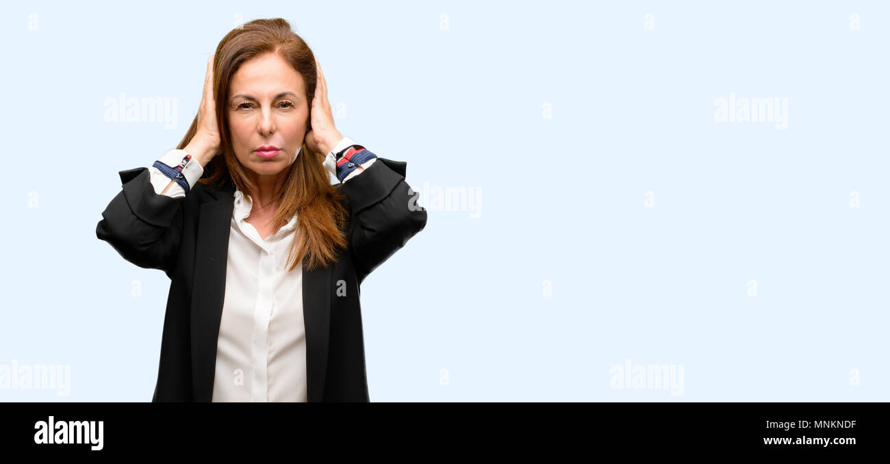 Middle age woman wearing jacket covering ears ignoring annoying loud ...