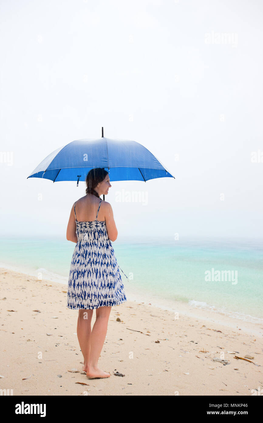 Woman beach umbrella rain hi-res stock photography and images - Alamy