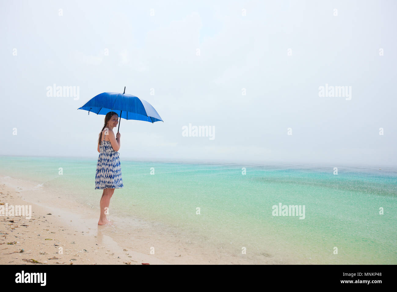Woman beach umbrella rain hi-res stock photography and images - Alamy