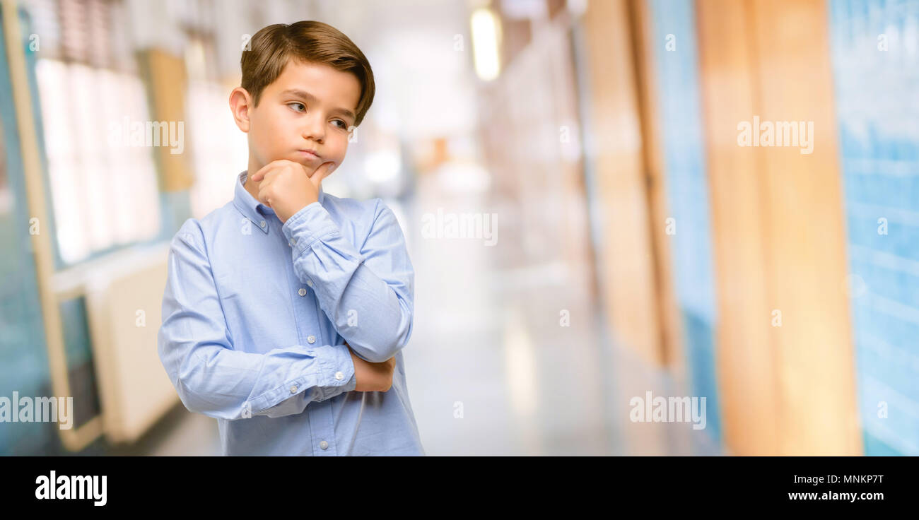Handsome toddler child with green eyes doubt expression, confuse and ...