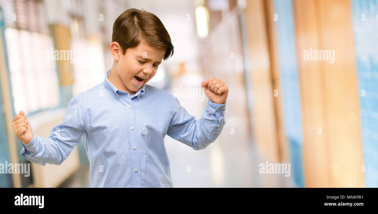 Handsome toddler child with green eyes happy and excited expressing ...