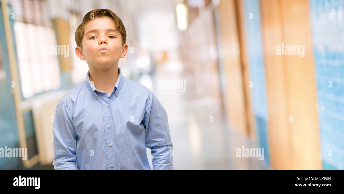Handsome toddler child with green eyes expressing love, blows kiss at ...