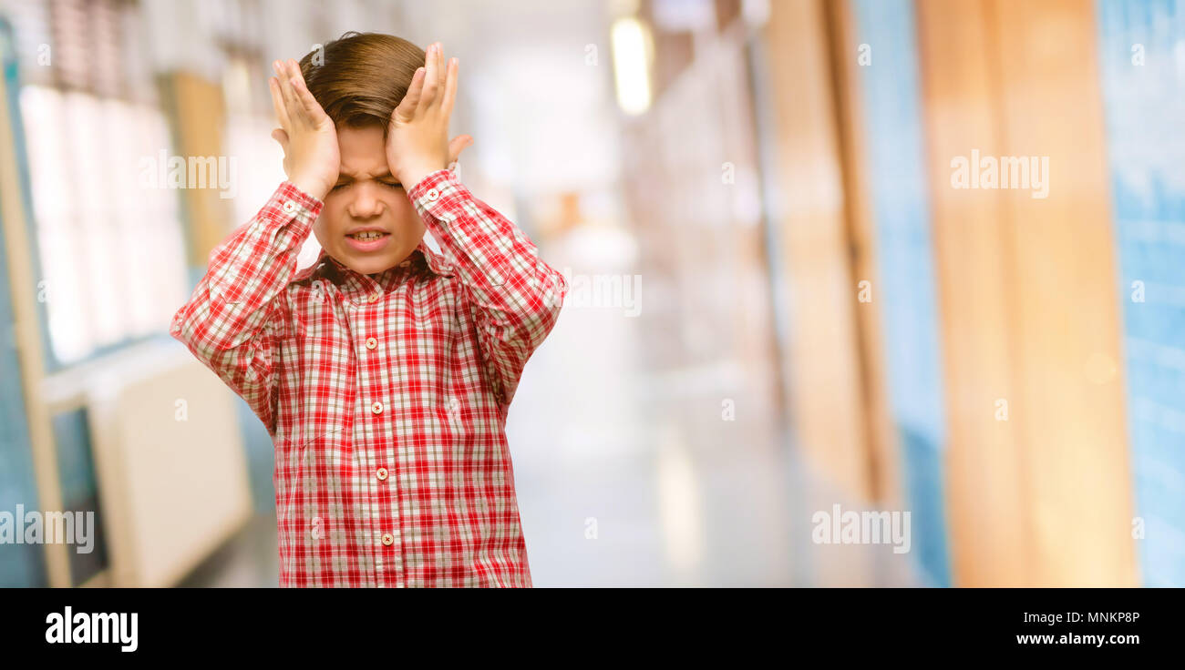 Handsome toddler child with green eyes terrified and nervous expressing ...