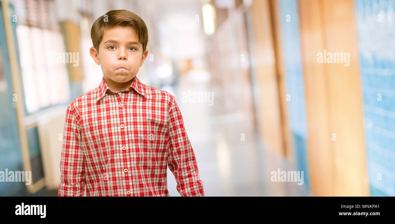 Handsome toddler child with green eyes puffing out cheeks, having fun ...