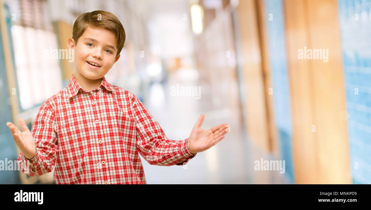 Handsome toddler child with green eyes confident and happy with a big ...