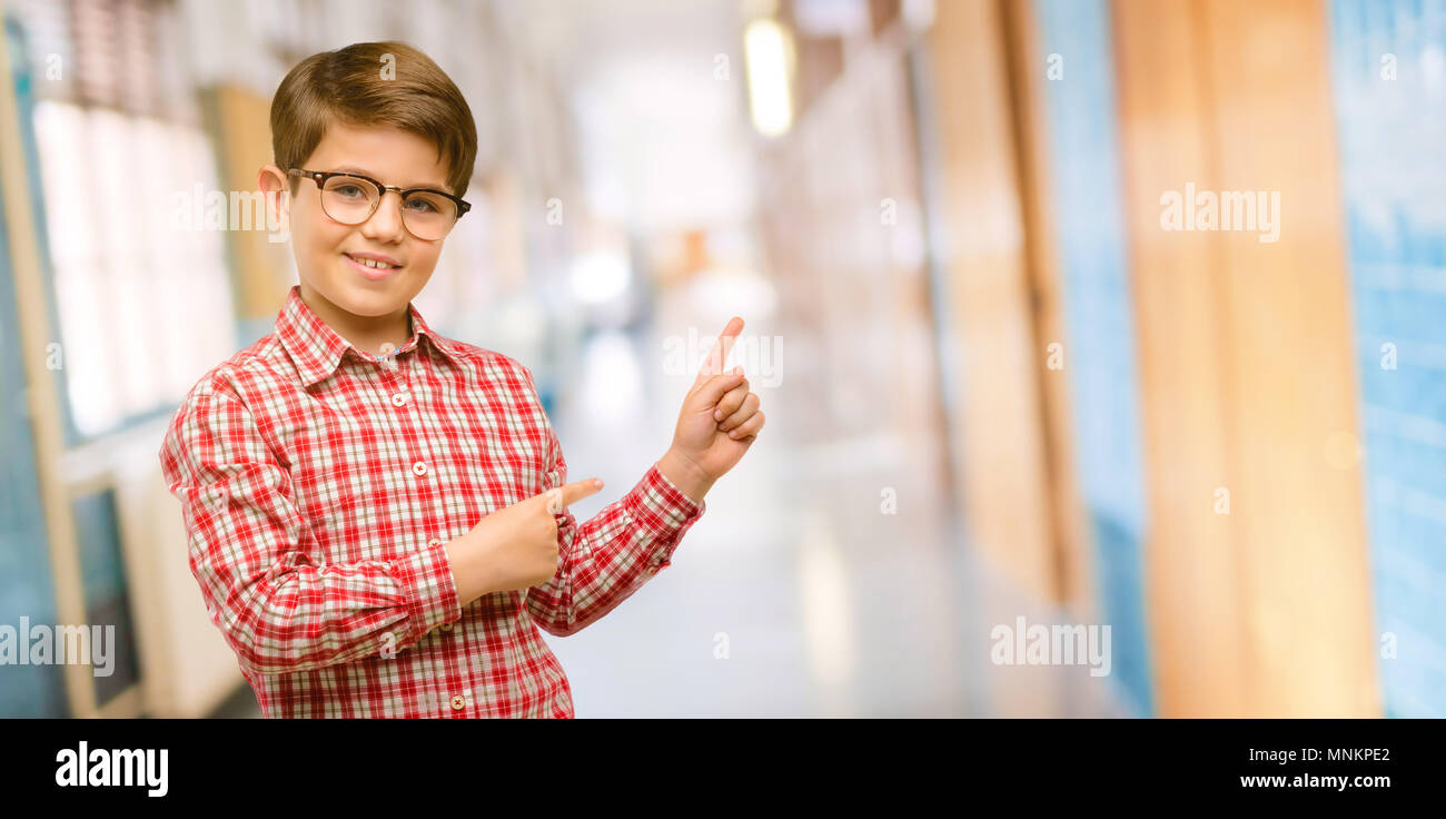 Handsome toddler child with green eyes pointing away side with fingers ...