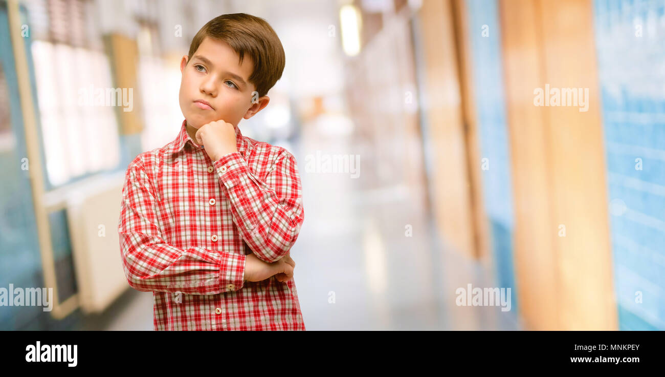 Handsome toddler child with green eyes thinking and looking up ...